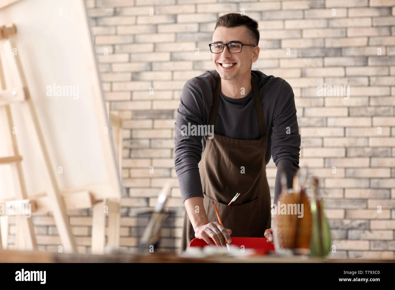 Happy male artist in workshop Stock Photo - Alamy