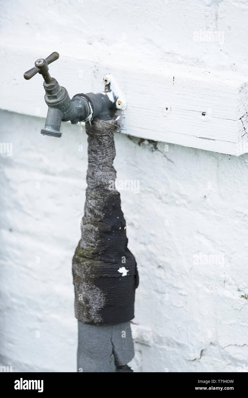 Bib tap outdoors on house external wall to water garden and car Stock ...