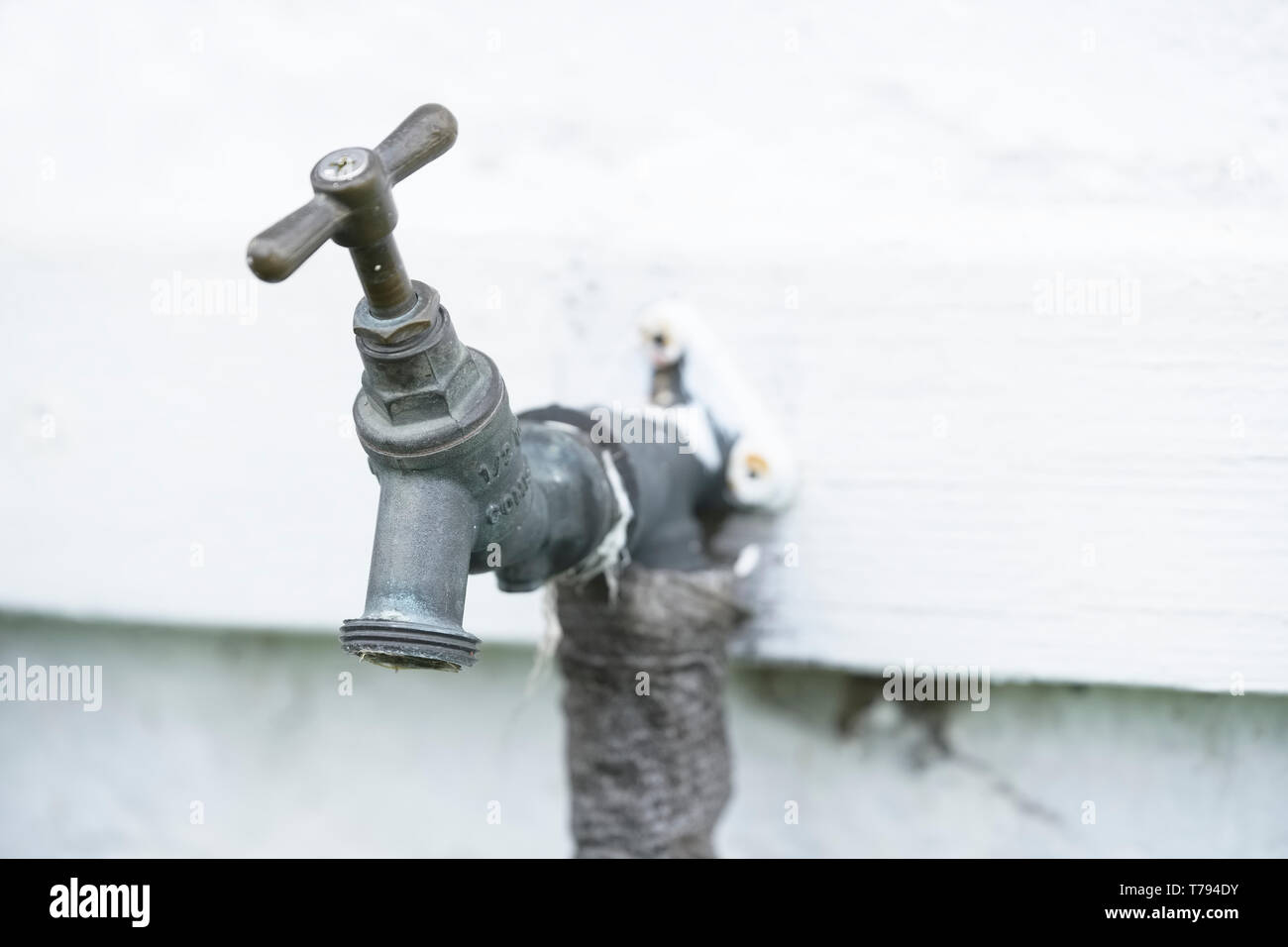 Bib tap outdoors on house external wall to water garden and car Stock ...