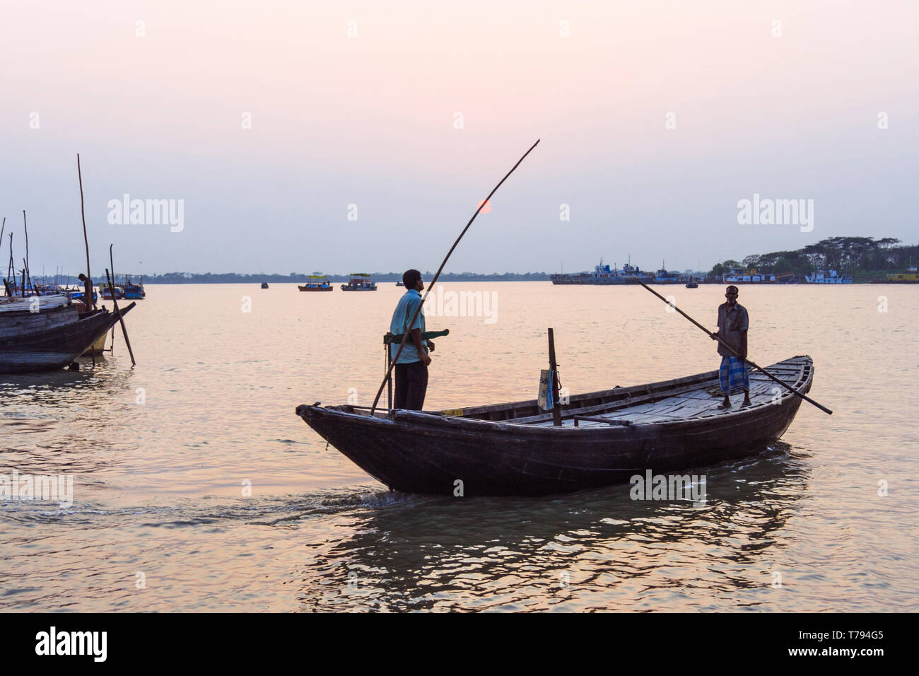 Mongla, Khulna Division, Bangladesh : Two men on a rowboat at the port ...