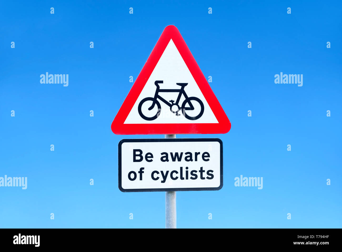 Beware of cyclists road safety sign against blue sky Stock Photo - Alamy