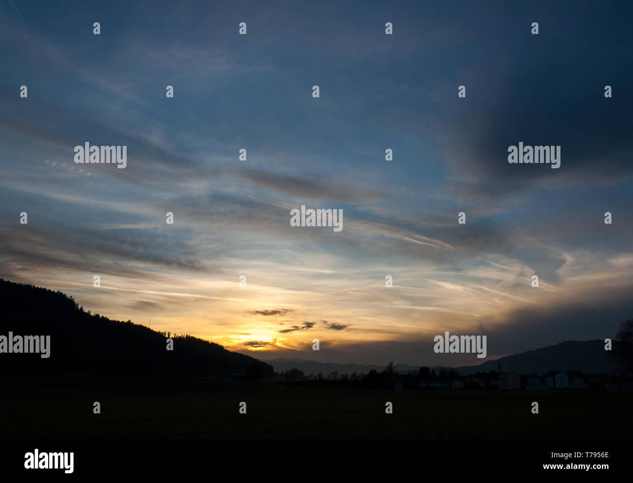 mystic sunset in the austrian alps with mighty clouds in front of the ...