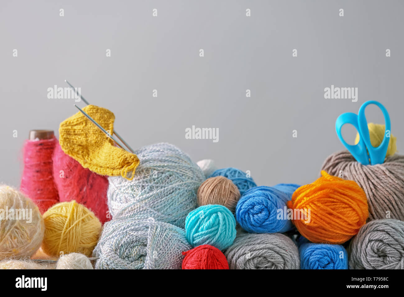 Colorful knitting yarn on grey background Stock Photo - Alamy