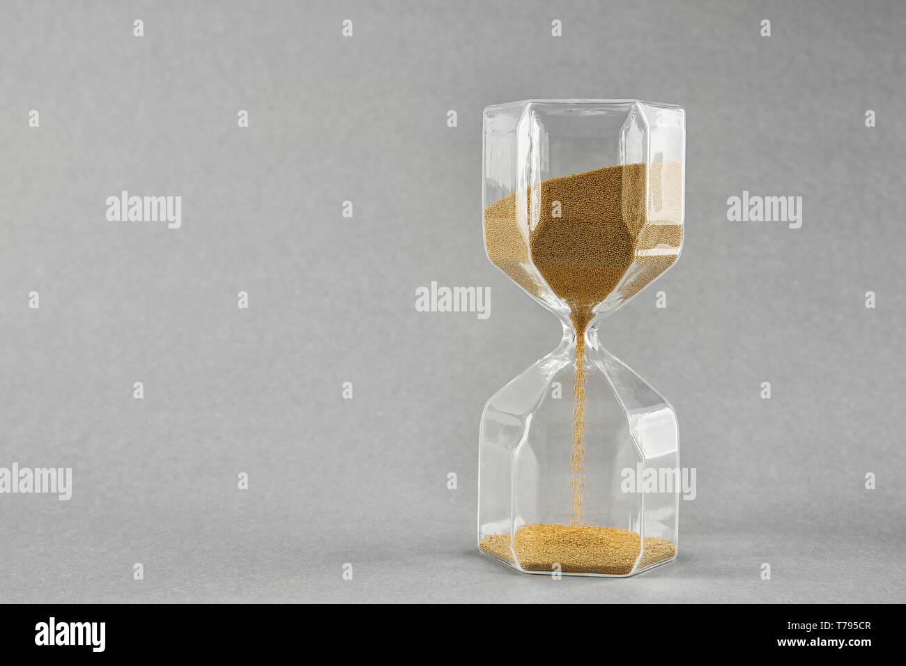 Hourglass on grey background. Time management concept Stock Photo - Alamy