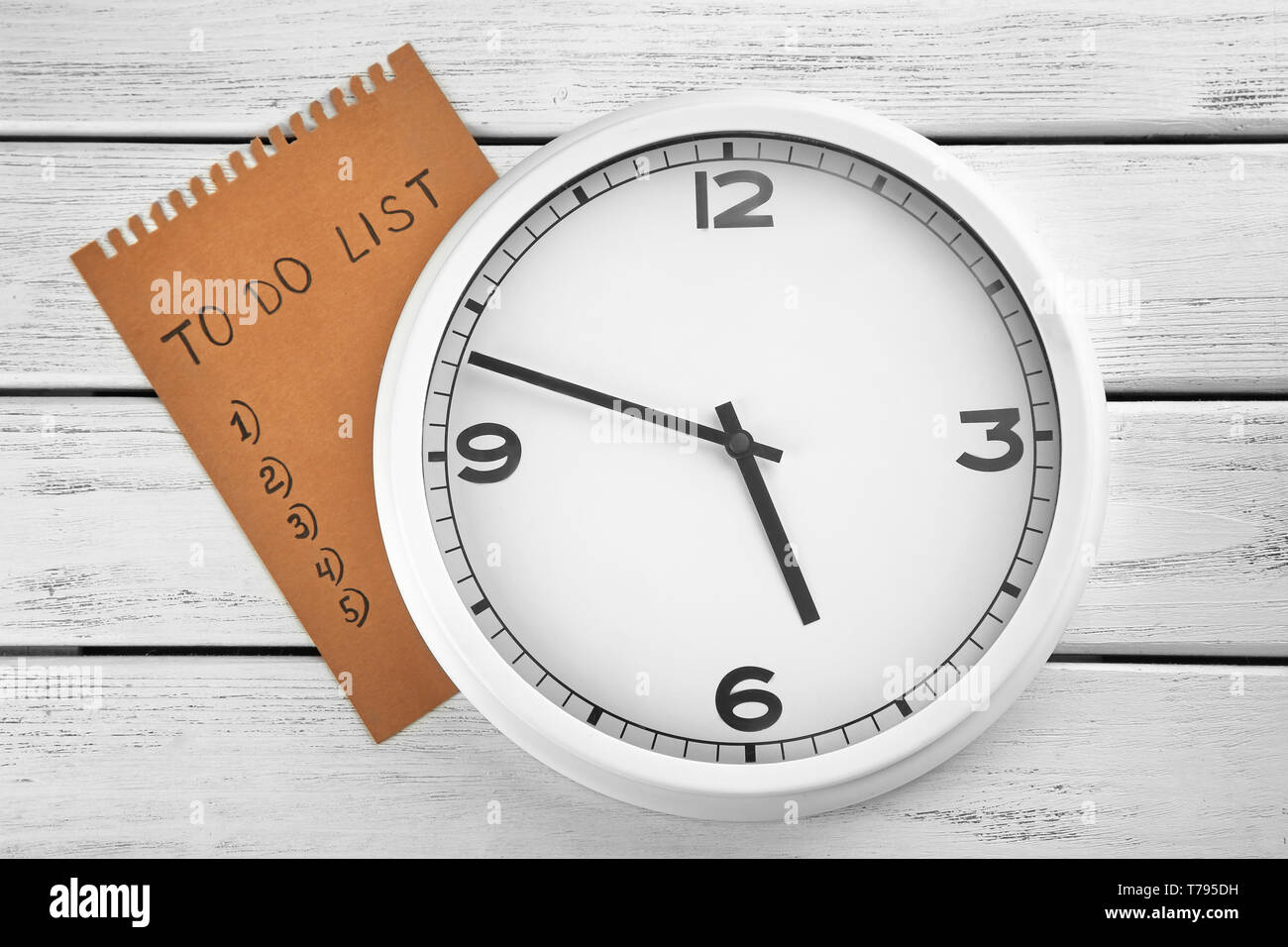 Clock with to-do list on wooden background. Time management concept ...