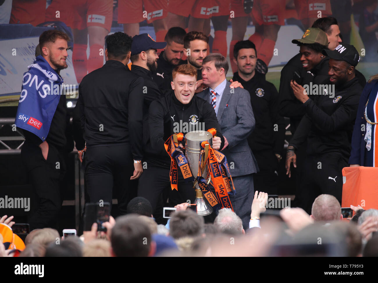 Luton Town's Arthur Read lifts the trophy during the victory parade at ...