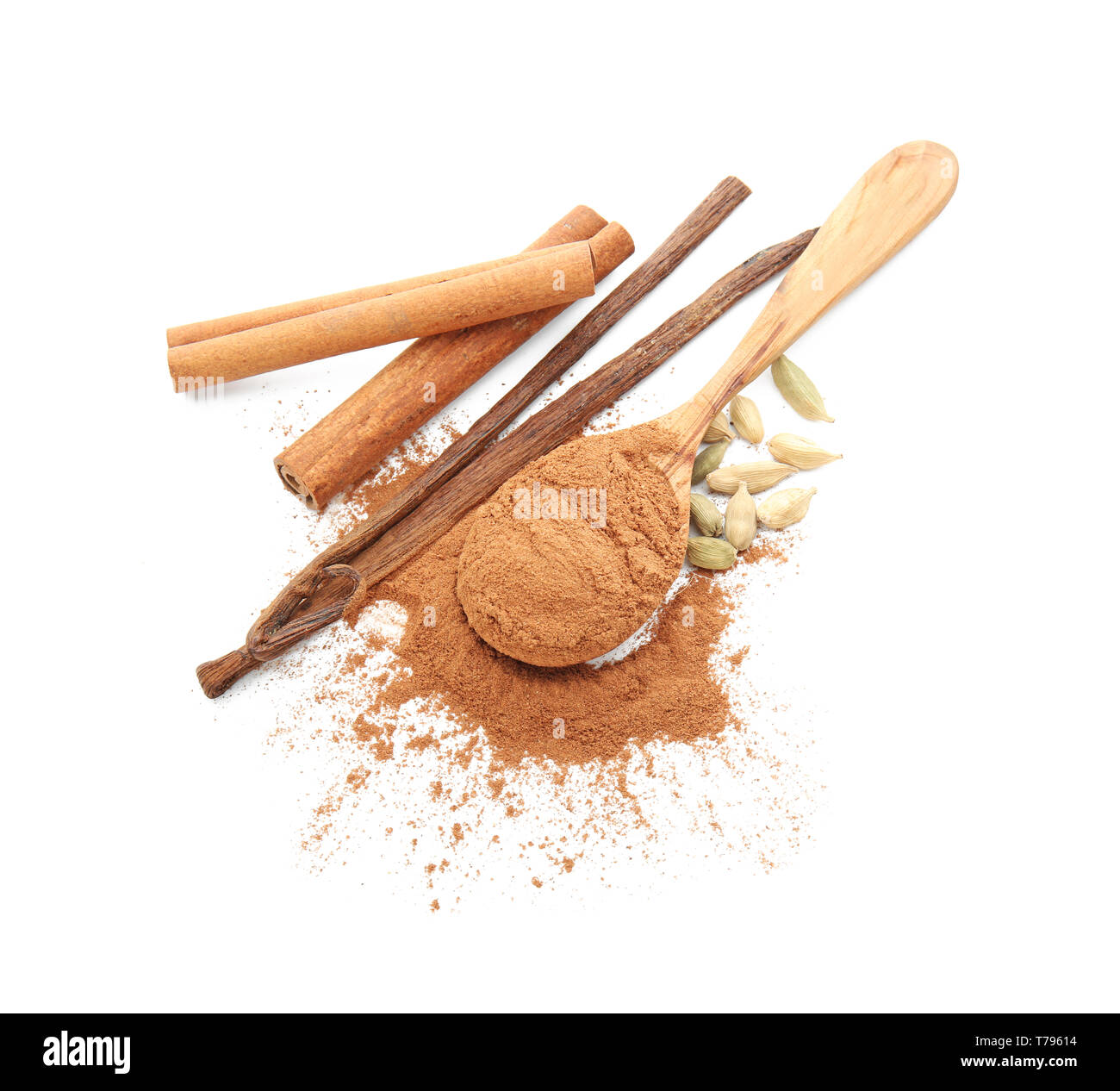 Spoon with cinnamon powder, cardamom and vanilla pods on white ...