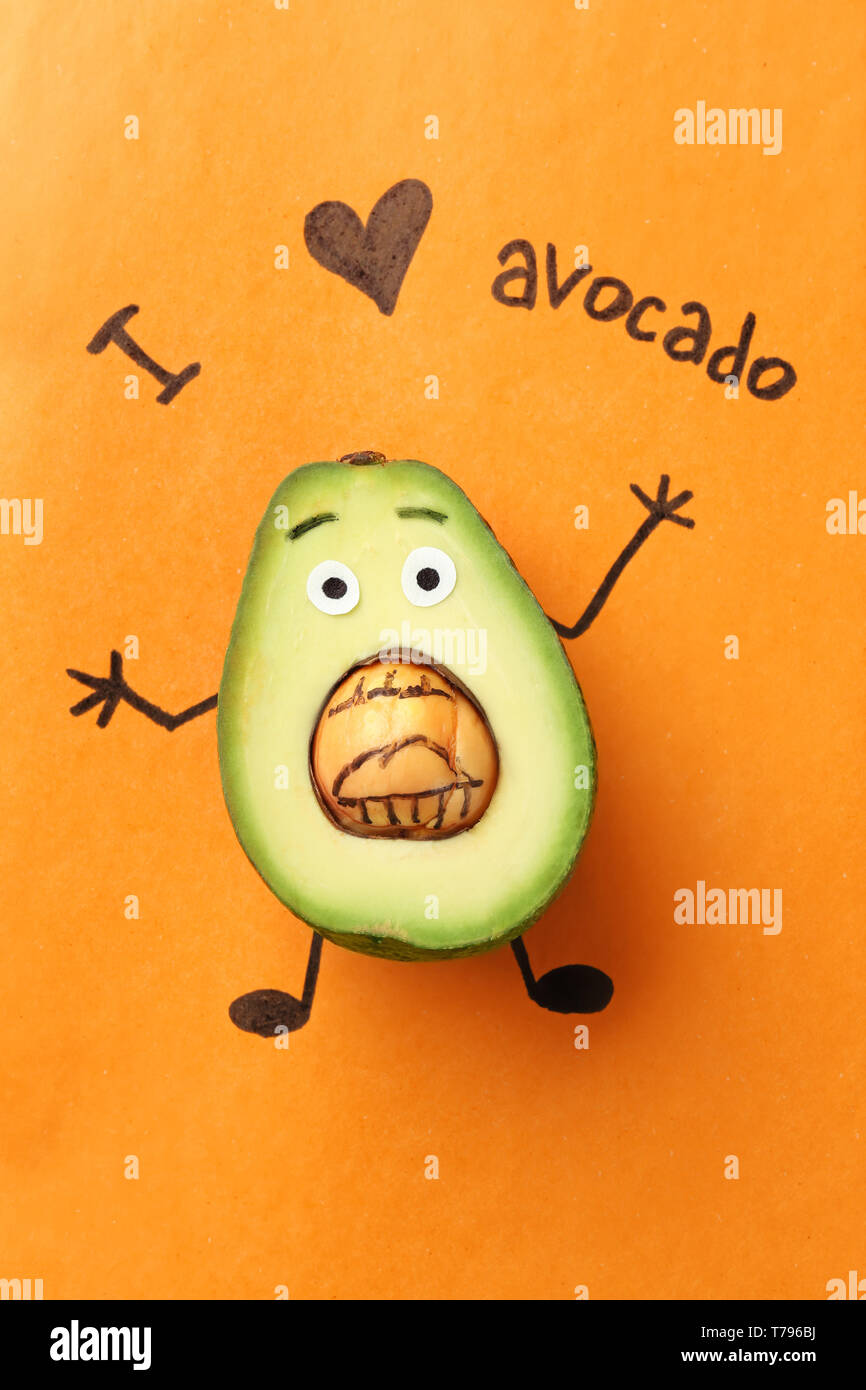 Funny avocado on color background Stock Photo - Alamy