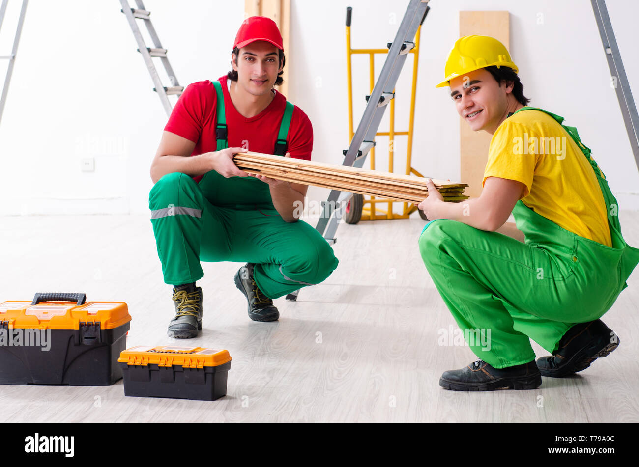 Two workers contractors working indoors Stock Photo - Alamy