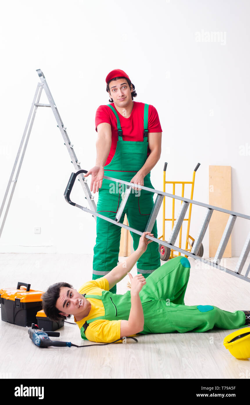 Injured worker and his workmate Stock Photo - Alamy
