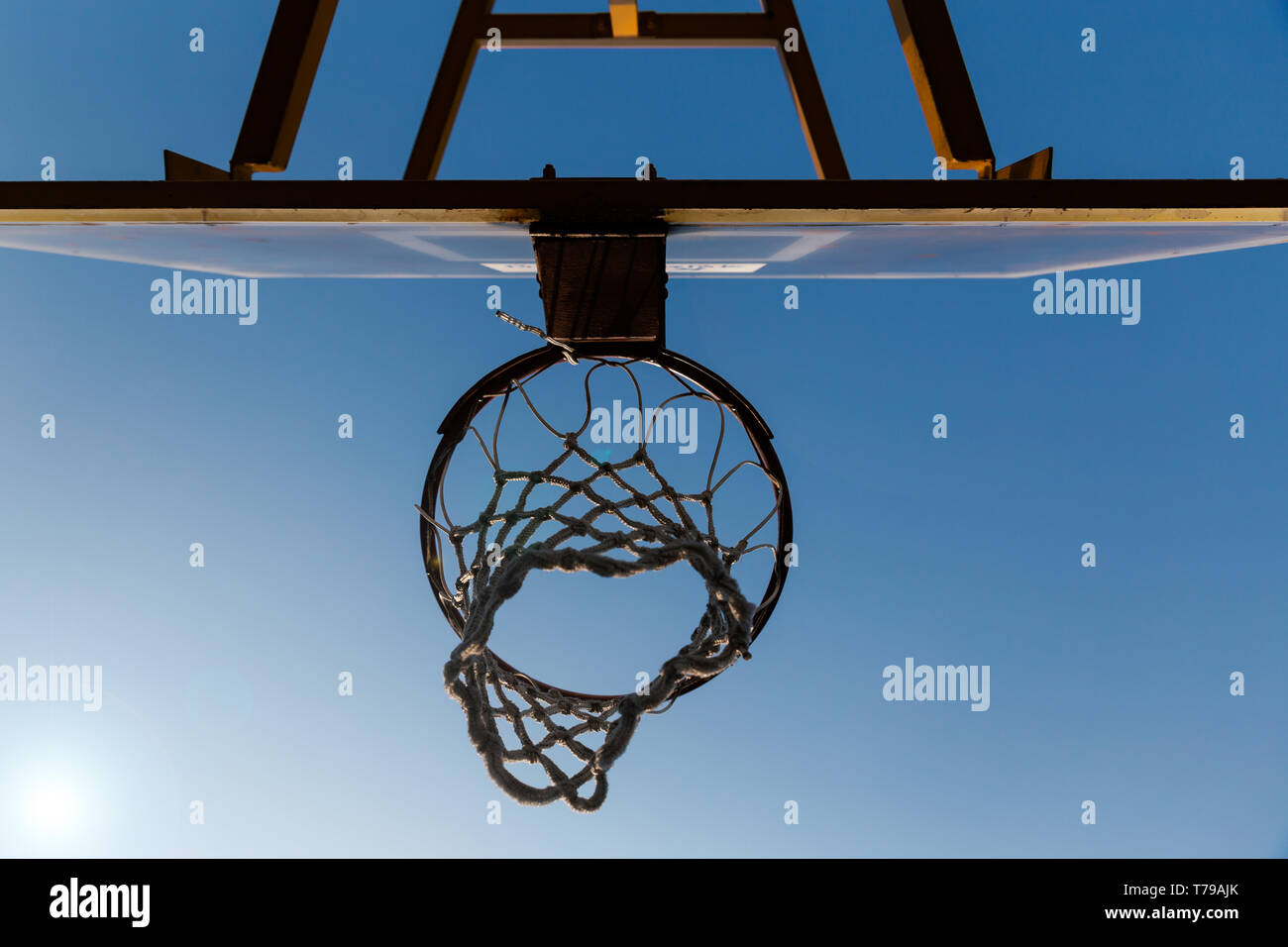 Bottom view of old basketball hoop and clear blue sky Stock Photo - Alamy