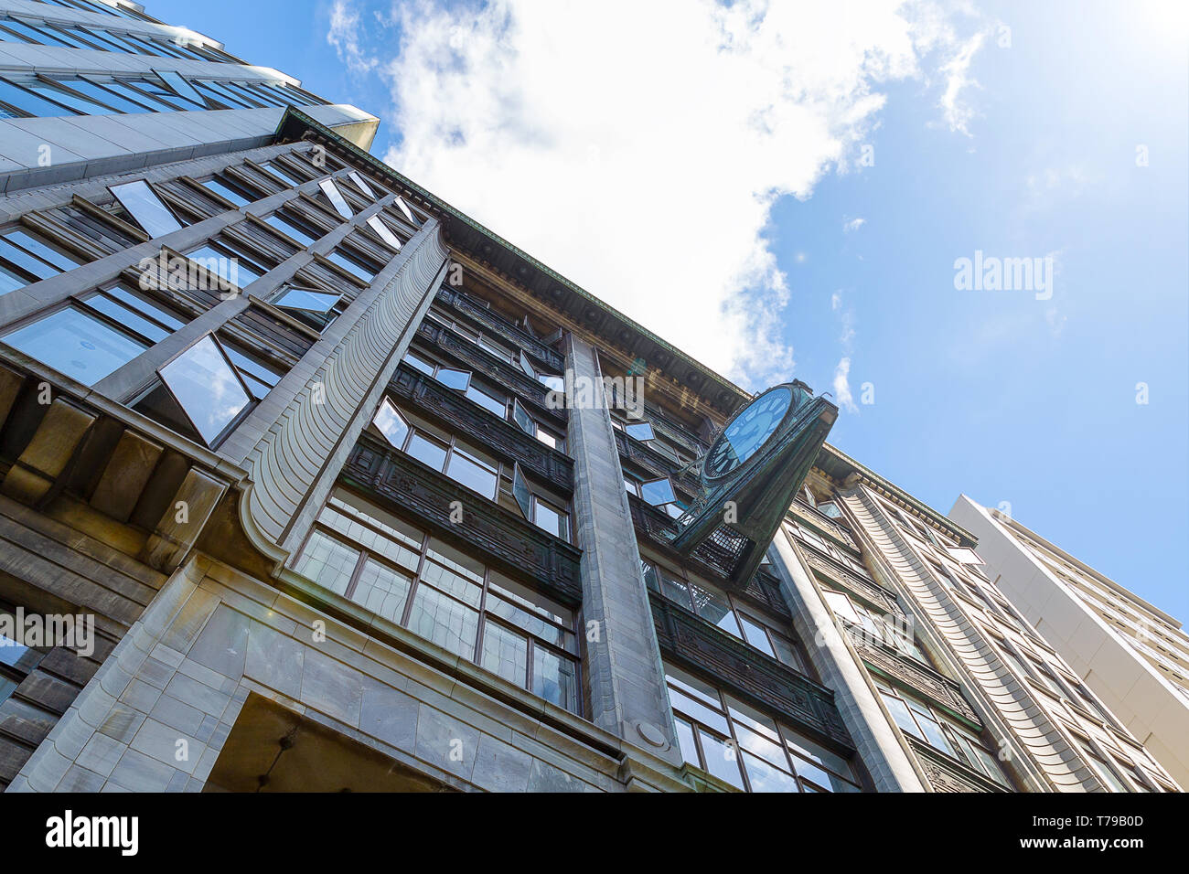 Old office building facade with clock and cloudy sky Stock Photo - Alamy