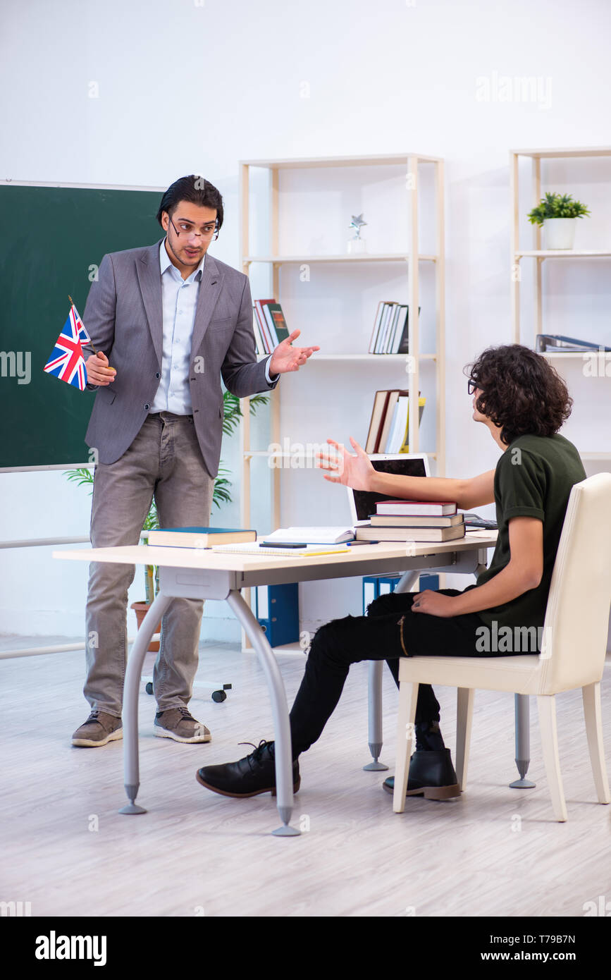 Male english teacher and student in the classroom Stock Photo - Alamy