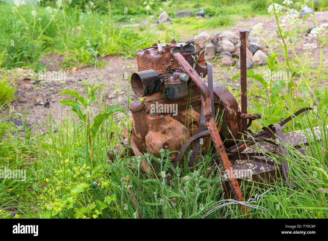 Old rusty car engine is standing on the street in the grass Stock Photo ...