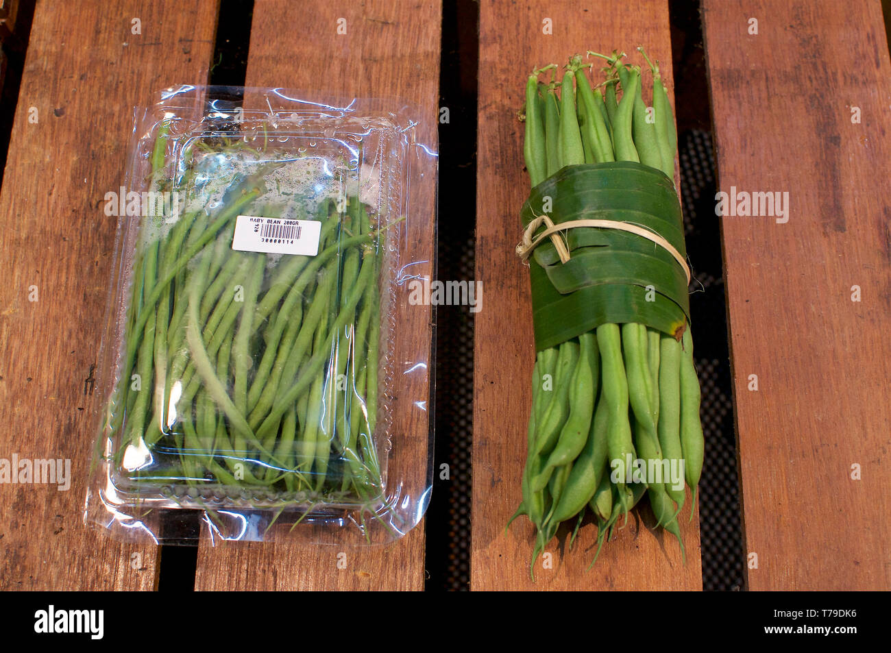 Beans bundled in a plastic package and other beans wrapped in Banana ...