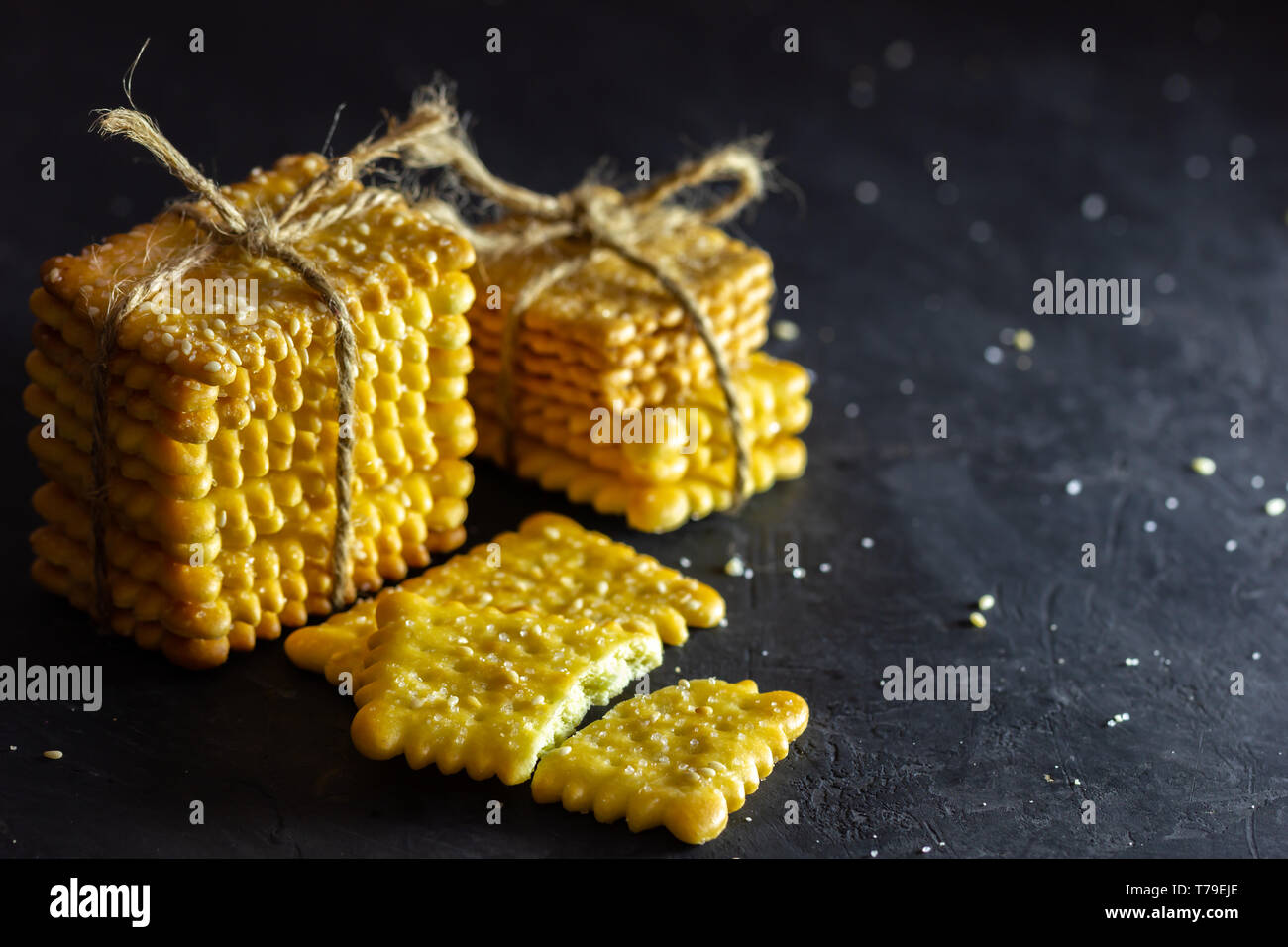Crackers are tied with hemp rope on table in dark background Stock ...