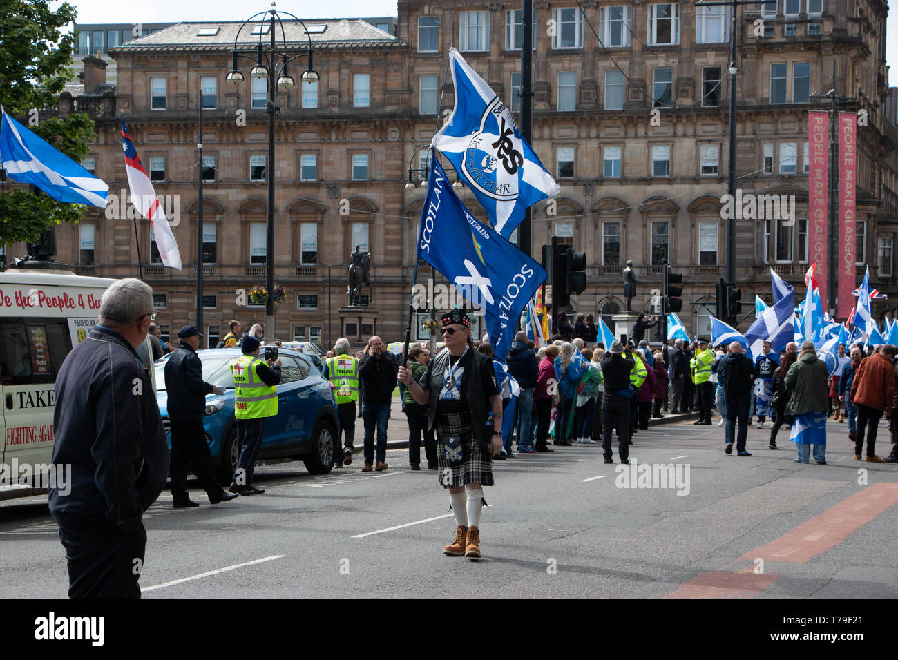 An especially proud-looking demonstrator holds up his twin flags during ...