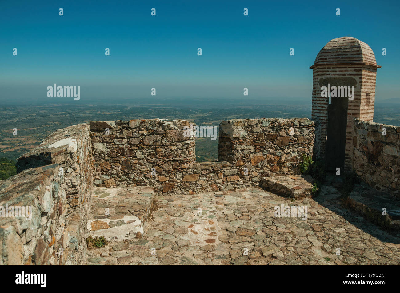 Watchtower made of bricks and stone wall with countryside landscape at ...