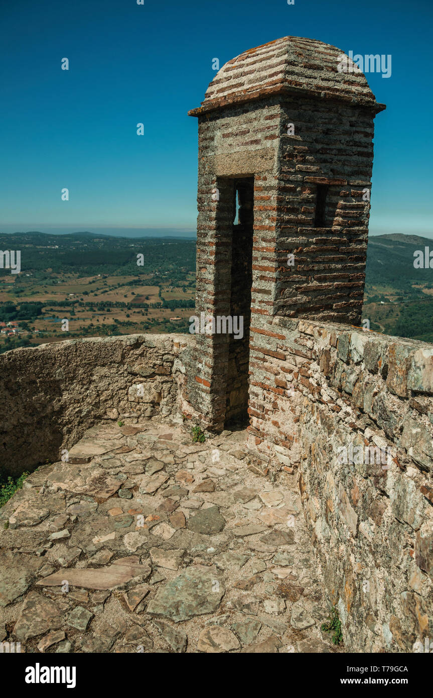 Watchtower made of bricks and stone wall with countryside landscape at ...