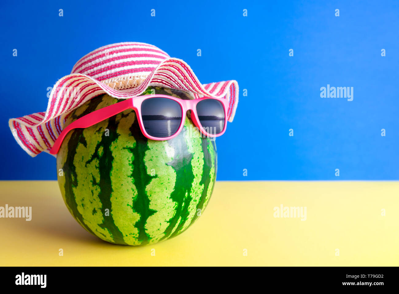 Summer frame with watermelon with hat and sunglasses on a blue and ...