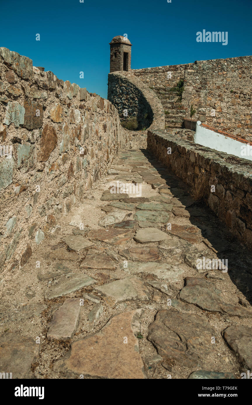 Pathway and stairs on top of thick stone wall going up to small ...