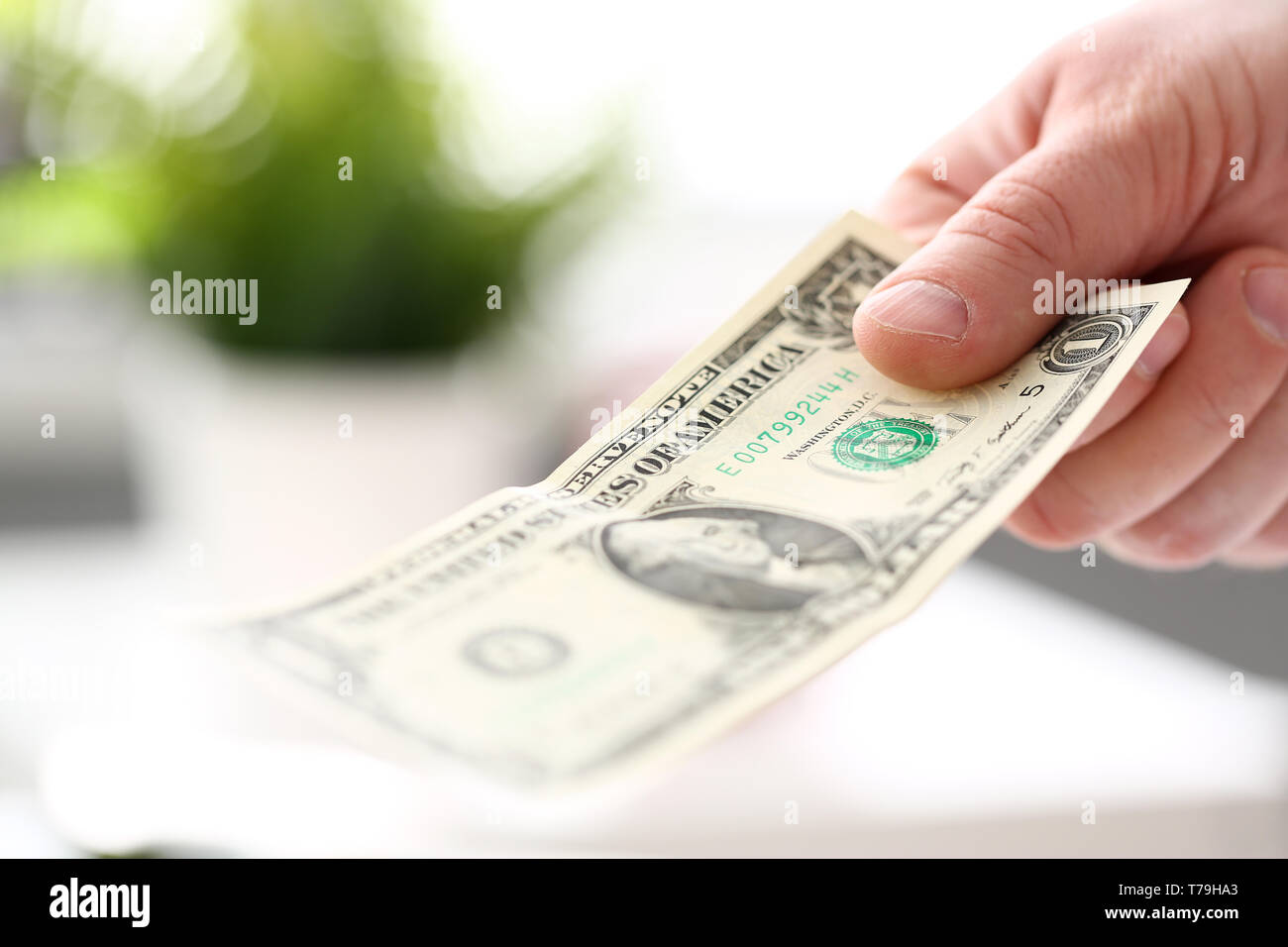 Male businessman hand hold paper us dollar note Stock Photo - Alamy