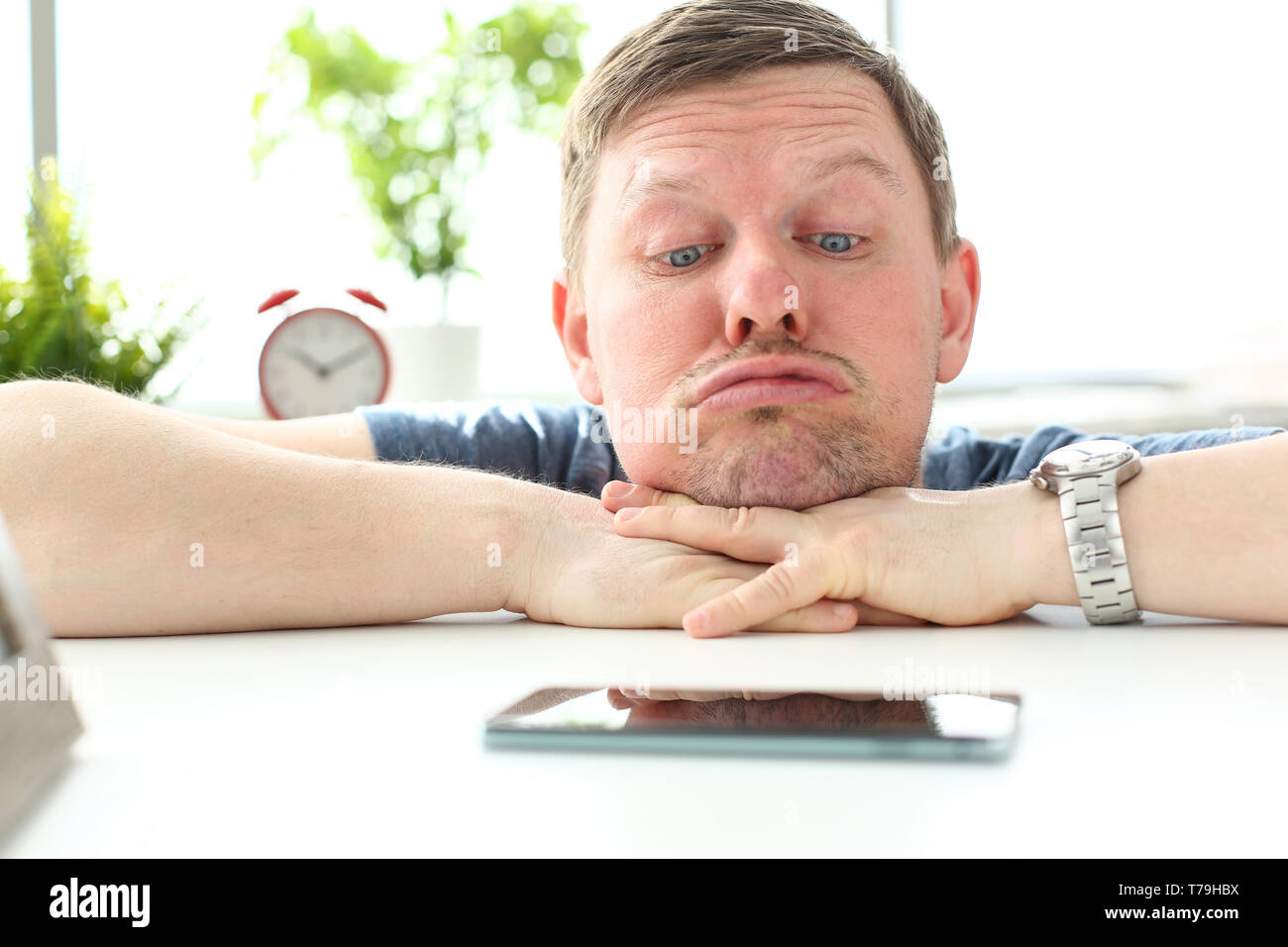 Man with funny facial expression staring at cellphone Stock Photo - Alamy
