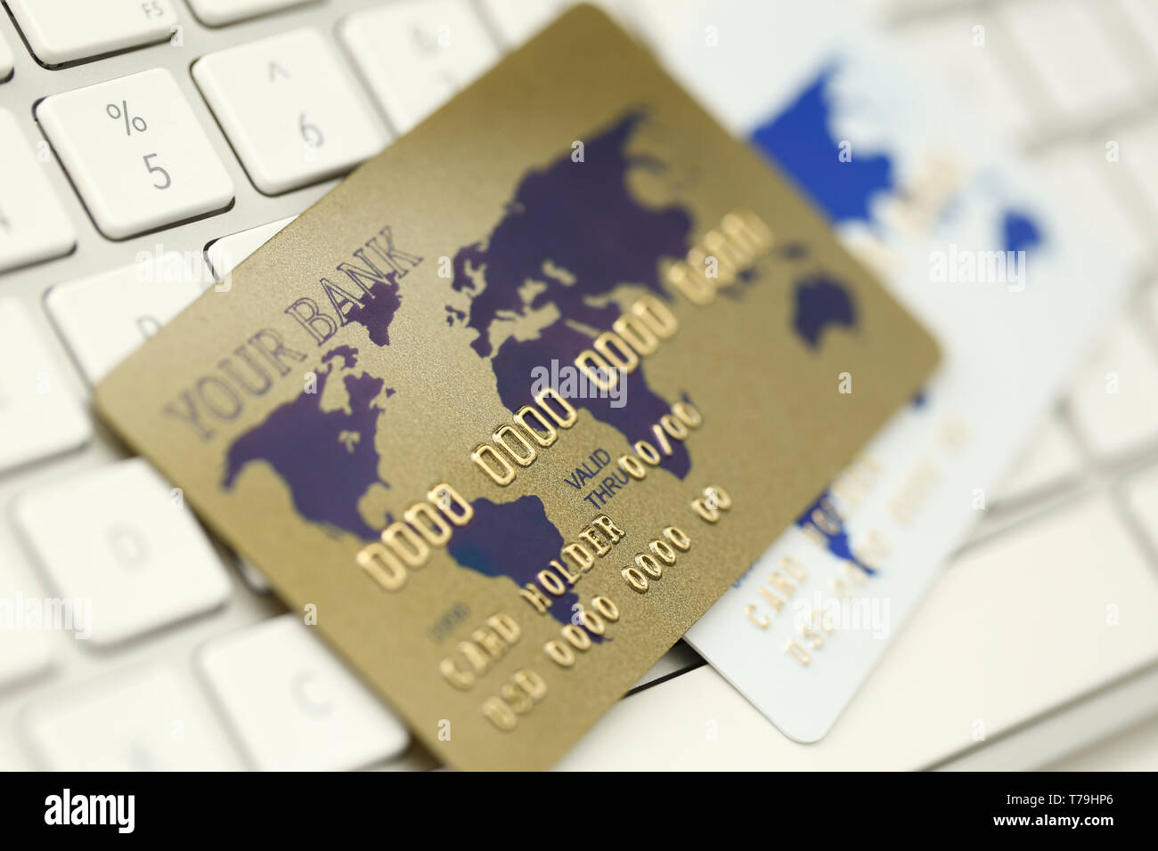 Gold plastic bank card on white keboard Stock Photo - Alamy