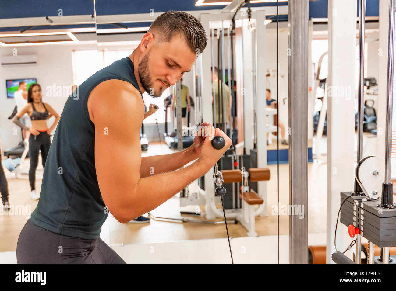 Young handsome man does lat pull up exercise in gym Stock Photo - Alamy
