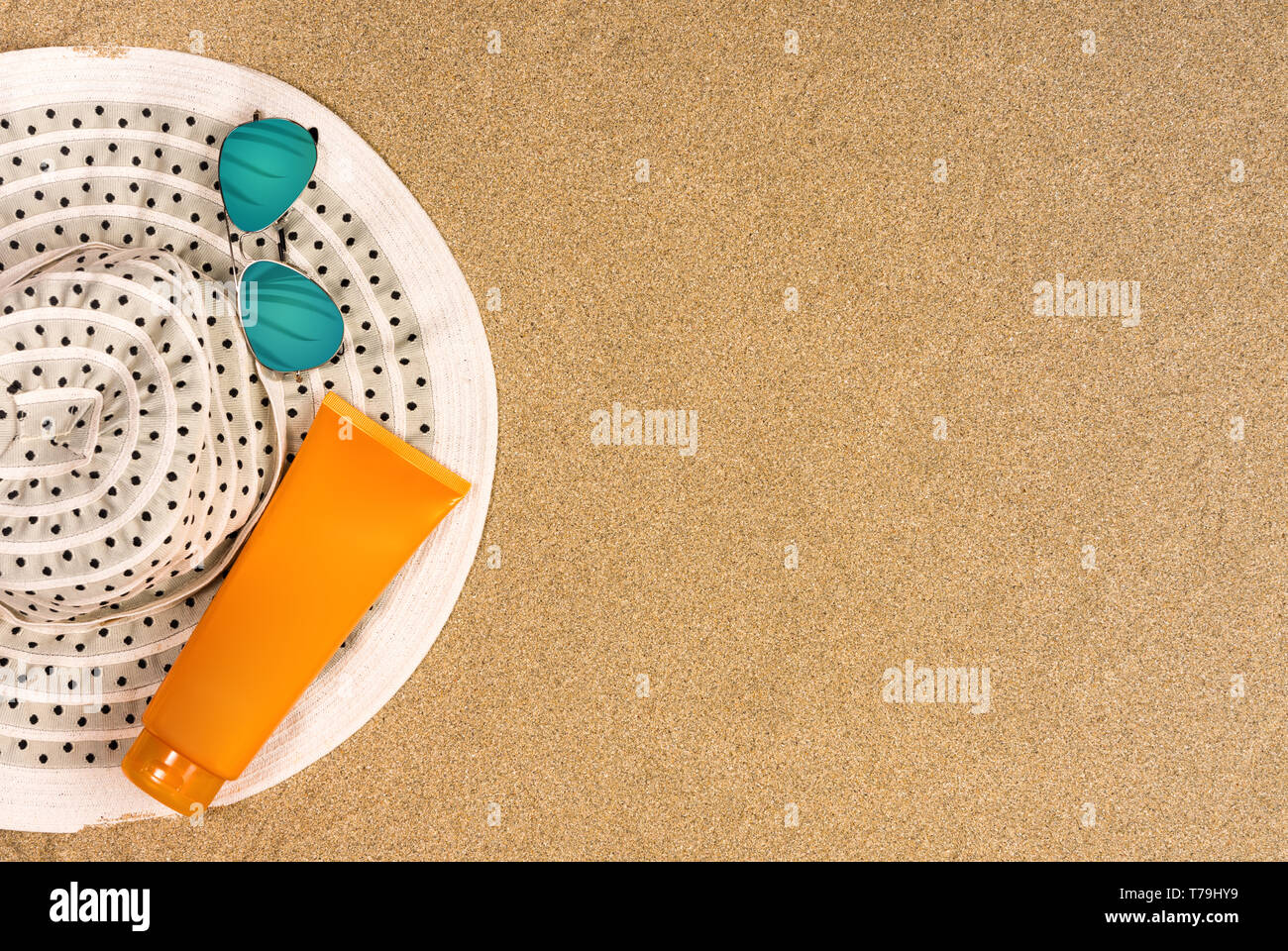 hat, sunglasses and sunscreen on sand background, top view Stock Photo ...