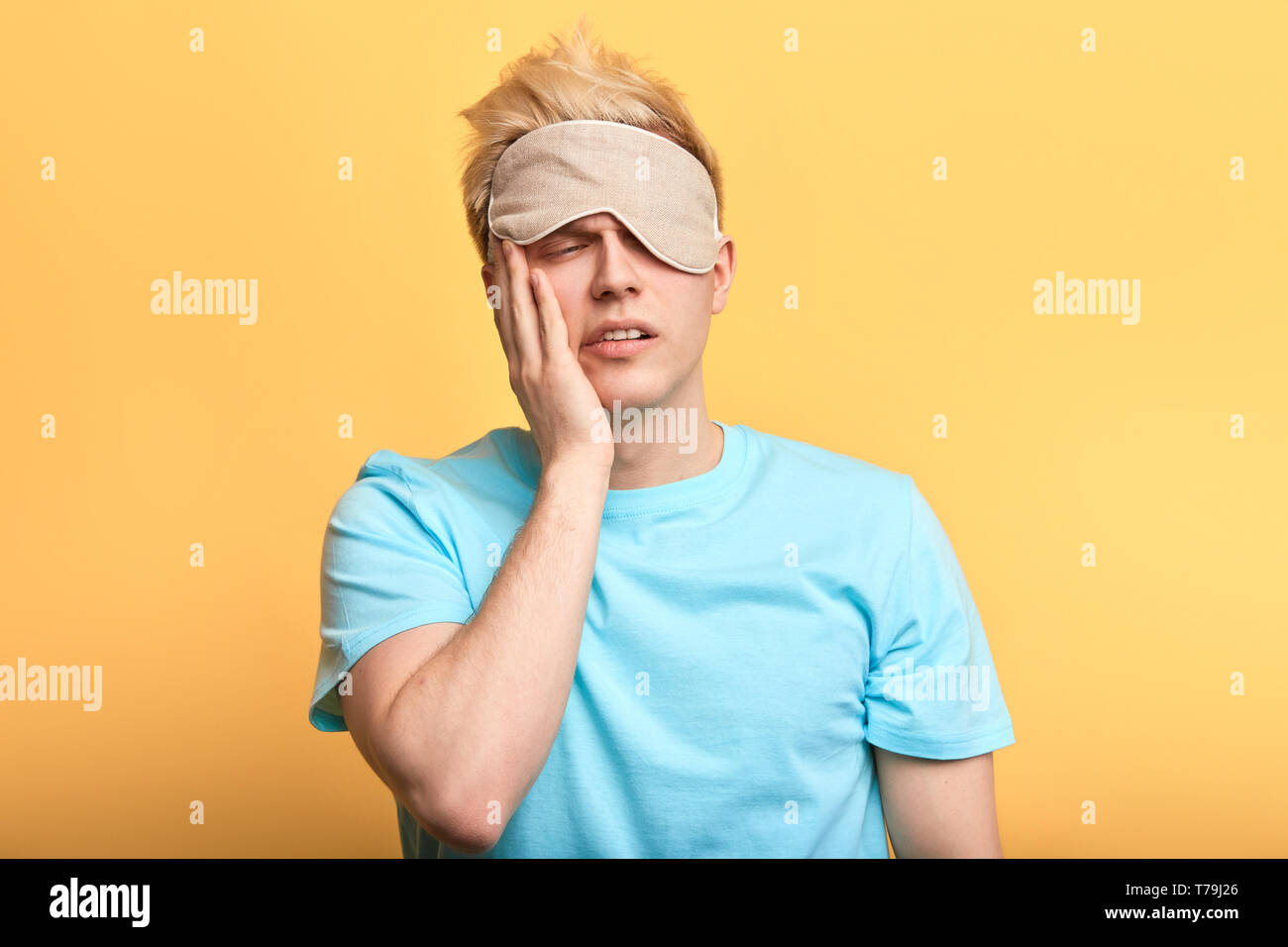 young sad unhappy man cannot wake up, get up in the morning. guy doesn ...