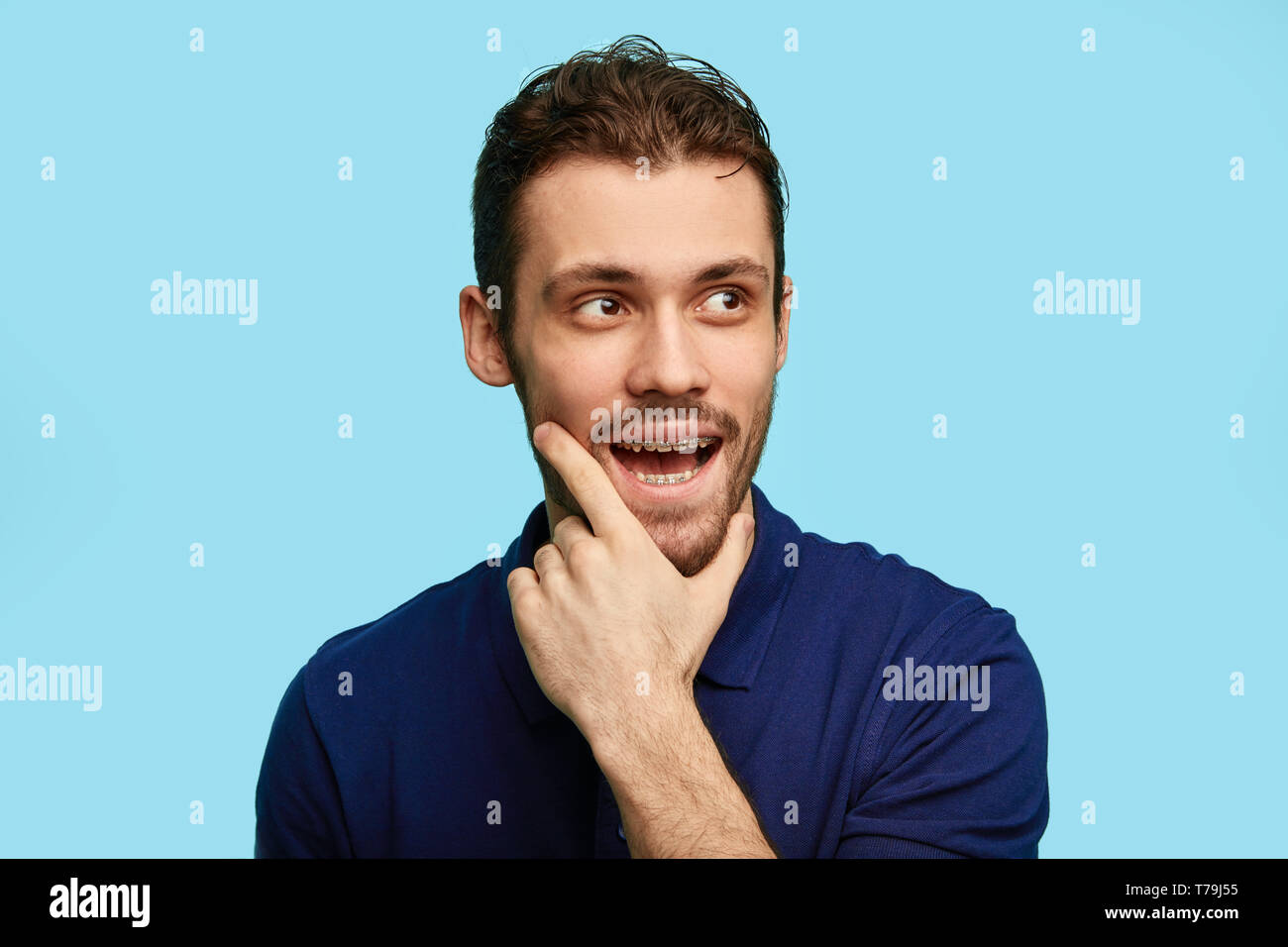 what a great, good idea.smiling cunning man in braces looking at the ...