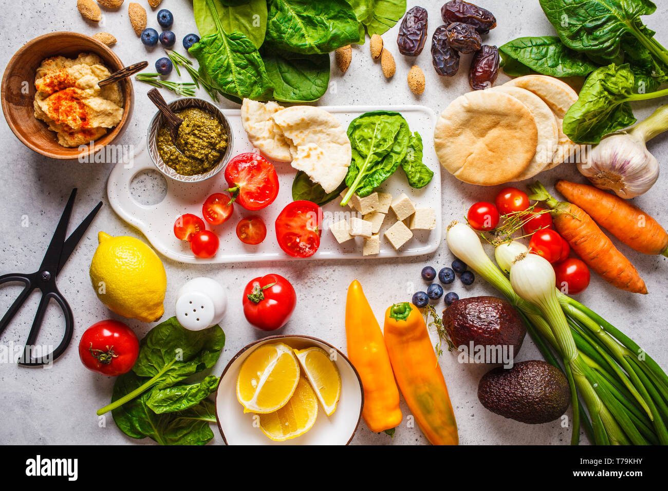 Healthy vegetarian food background. Vegetables, hummus, pesto and ...