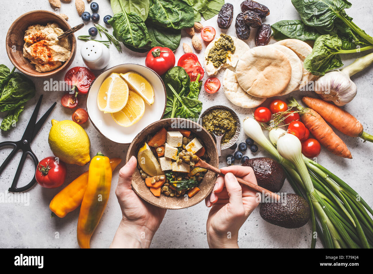 Healthy vegetarian food background. Vegetables, hummus, pesto and ...