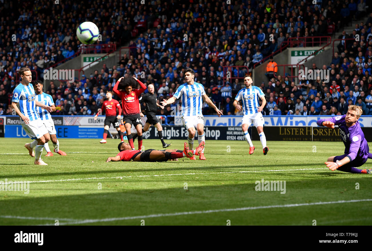 Manchester United's Marcus Rashford slips as he shoots at goal during ...