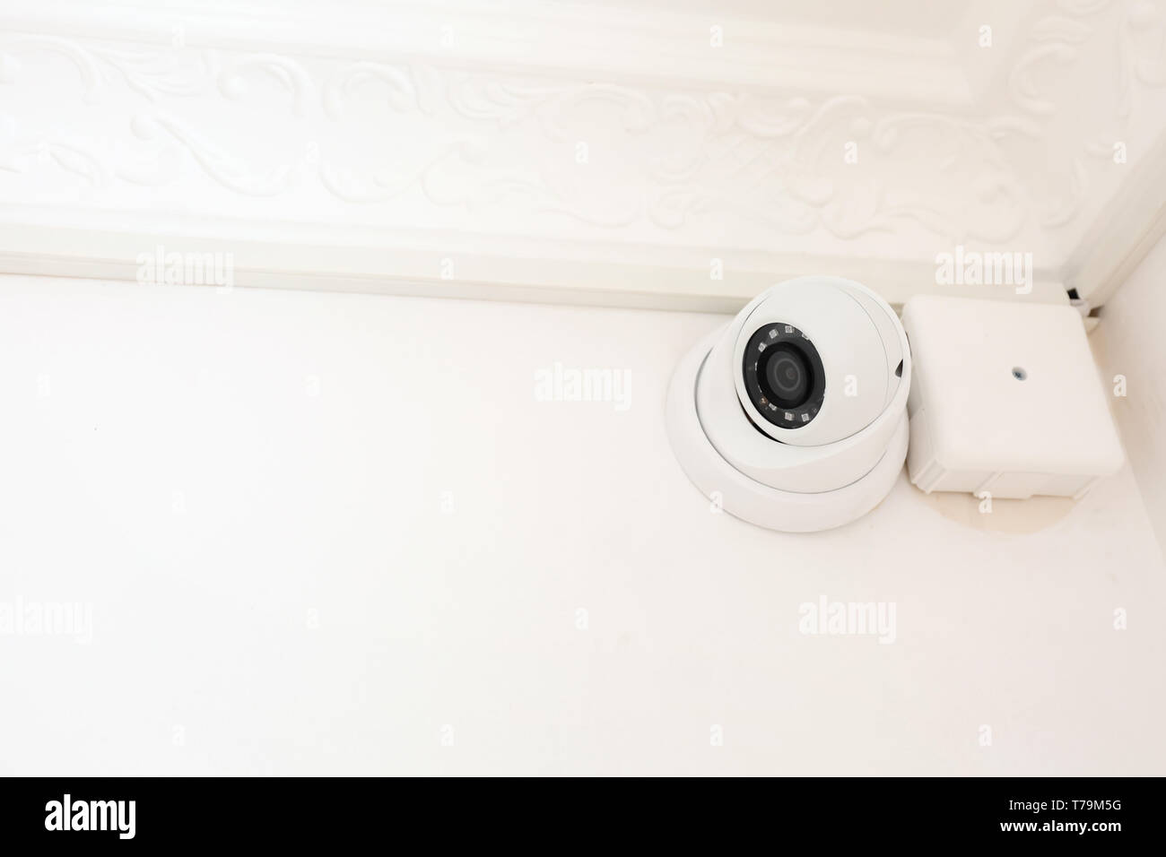 Modern CCTV camera installed on wall in room Stock Photo - Alamy