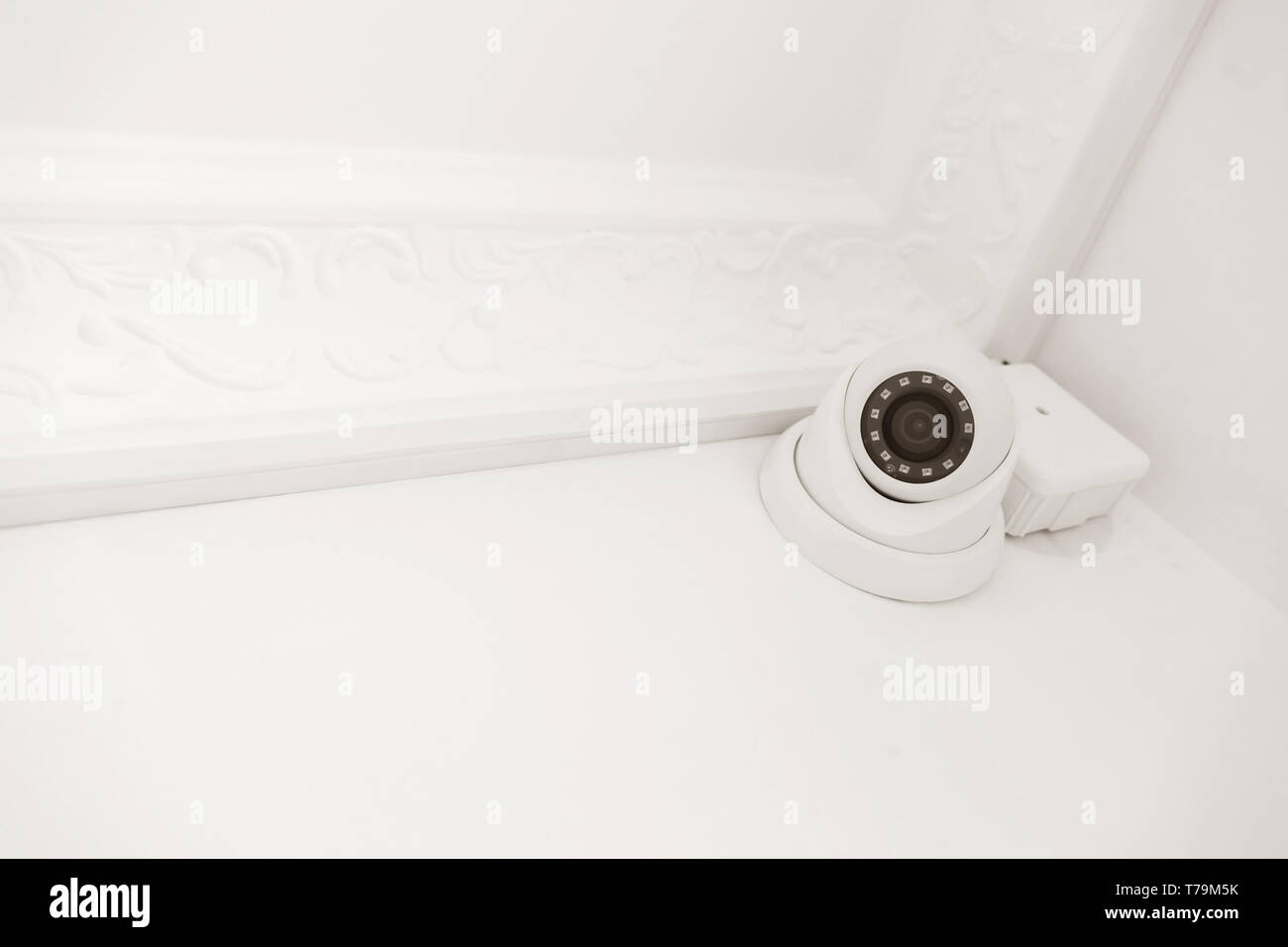 Modern CCTV camera installed on wall in room Stock Photo - Alamy