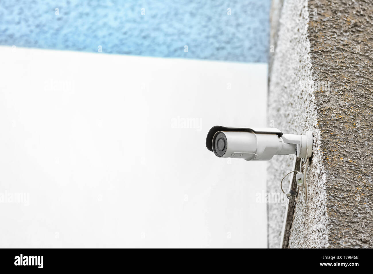 Modern CCTV camera installed on wall of building outdoors Stock Photo ...