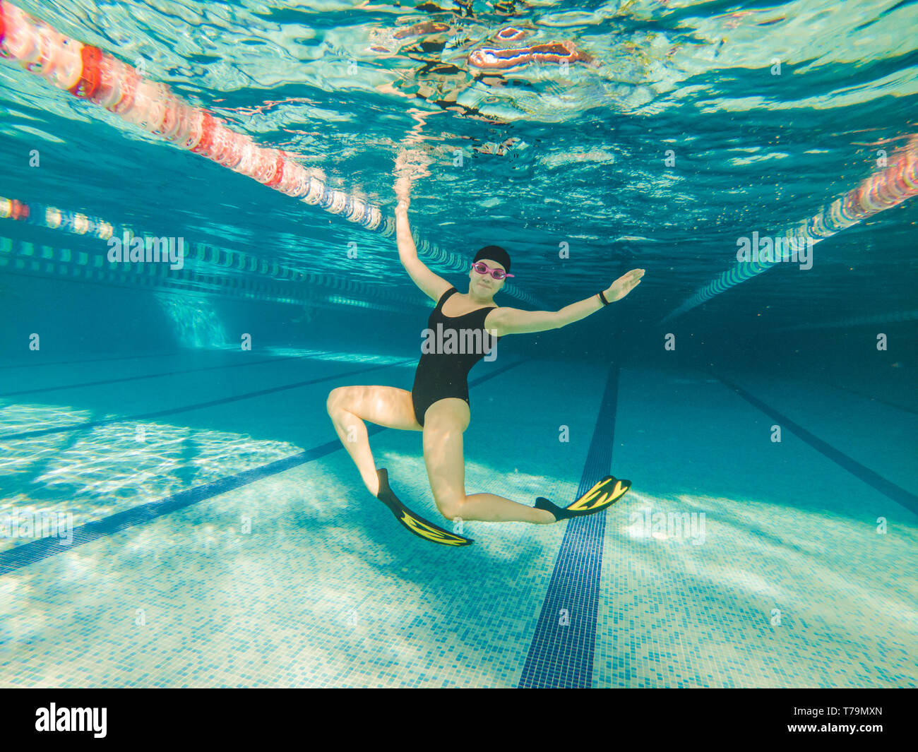 Woman swimming underwater with flippers hi-res stock photography and ...