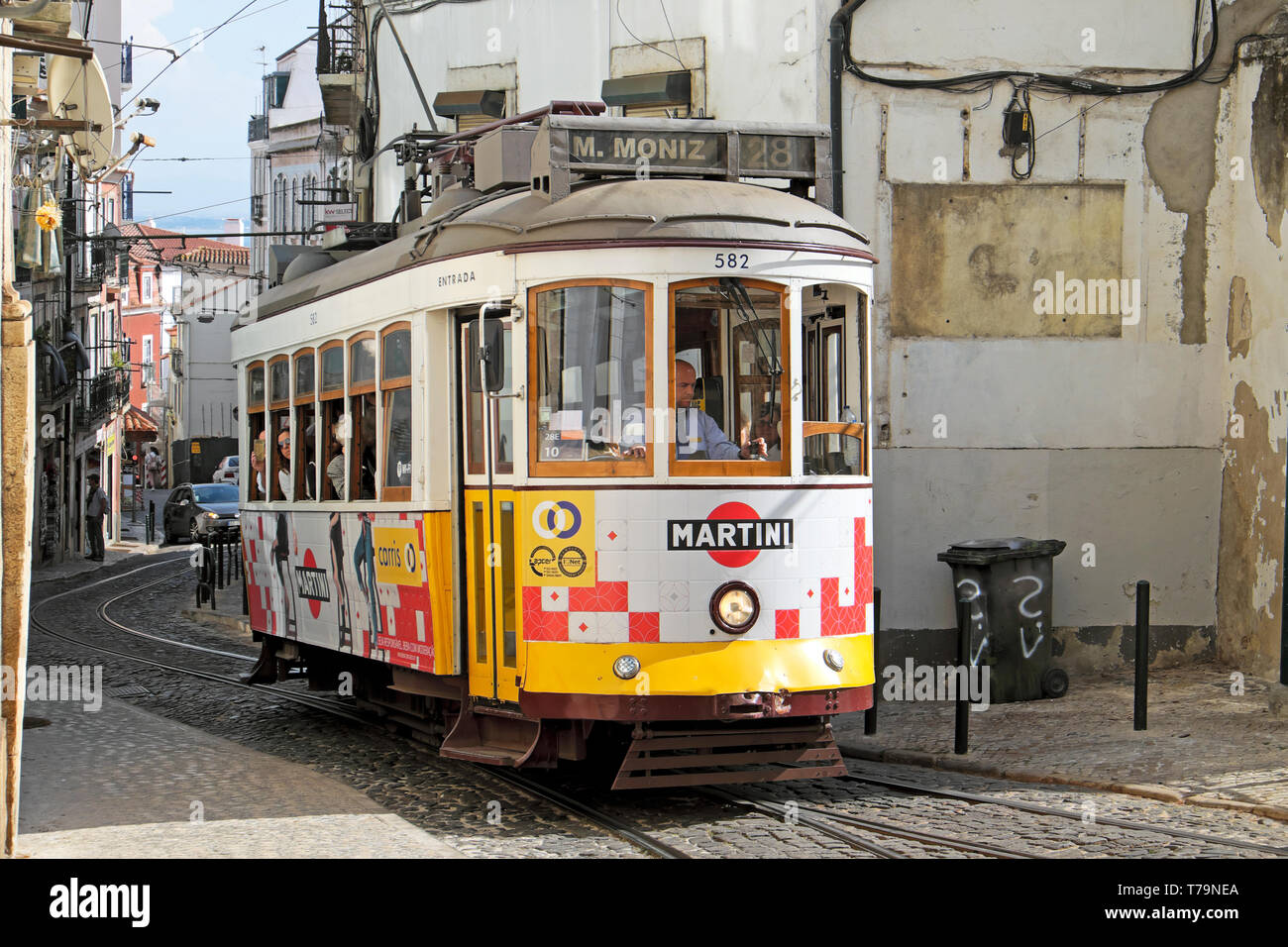 Alfama tram M. Moniz 28 public transportation on old street hill in ...