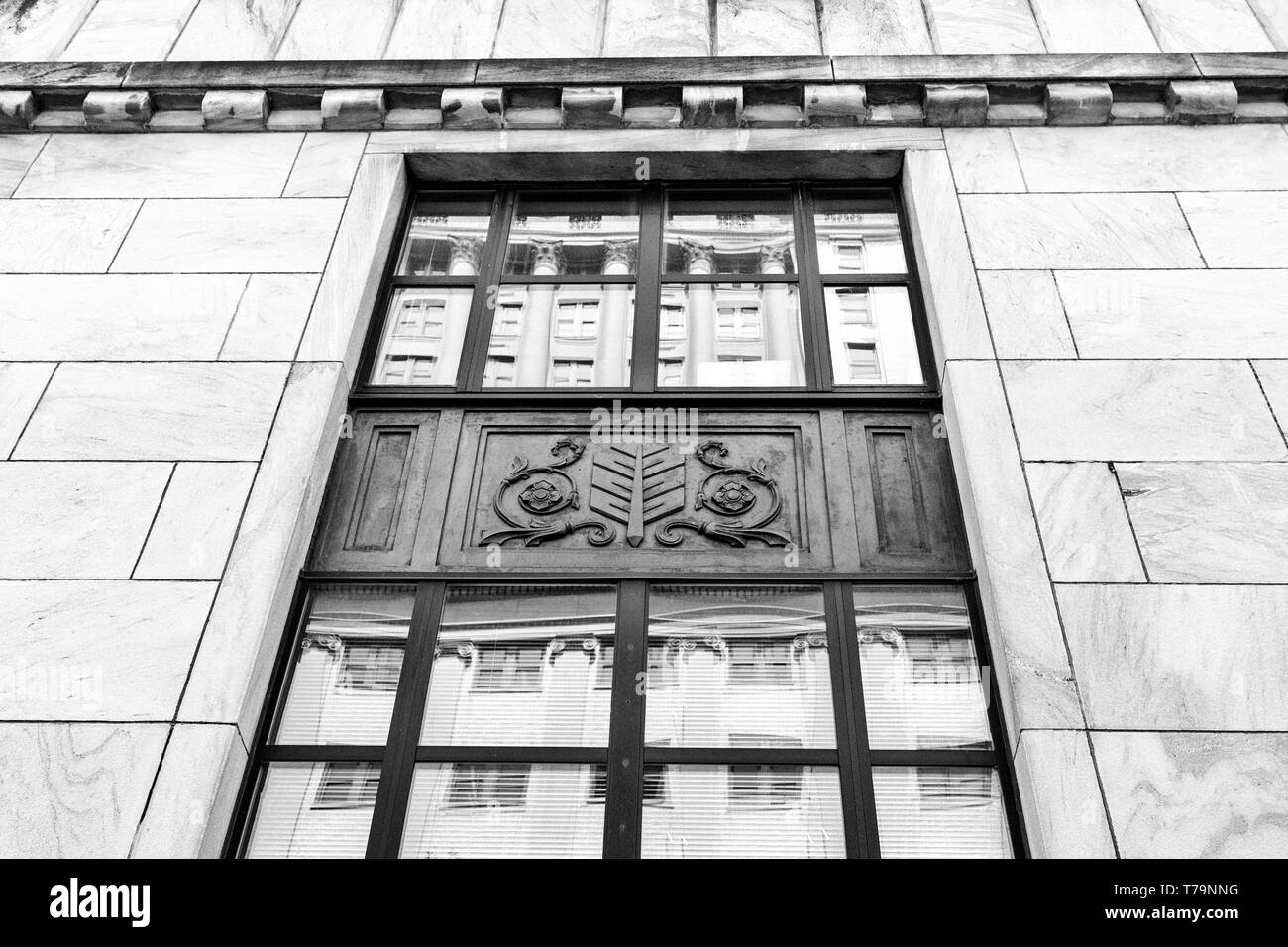 The federal courthouse is reflected in the windows of the City Building ...