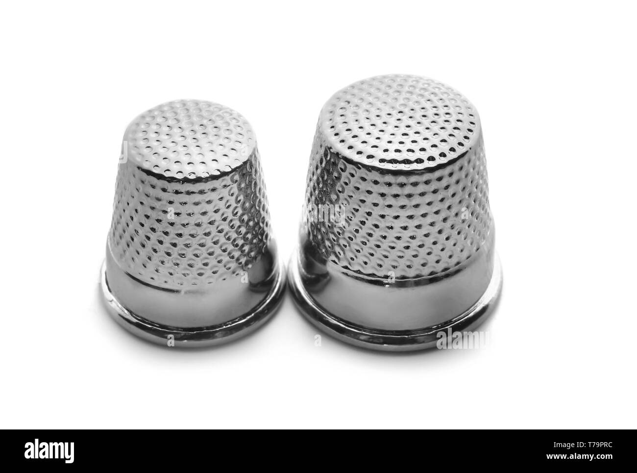 Metal thimbles on white background Stock Photo - Alamy