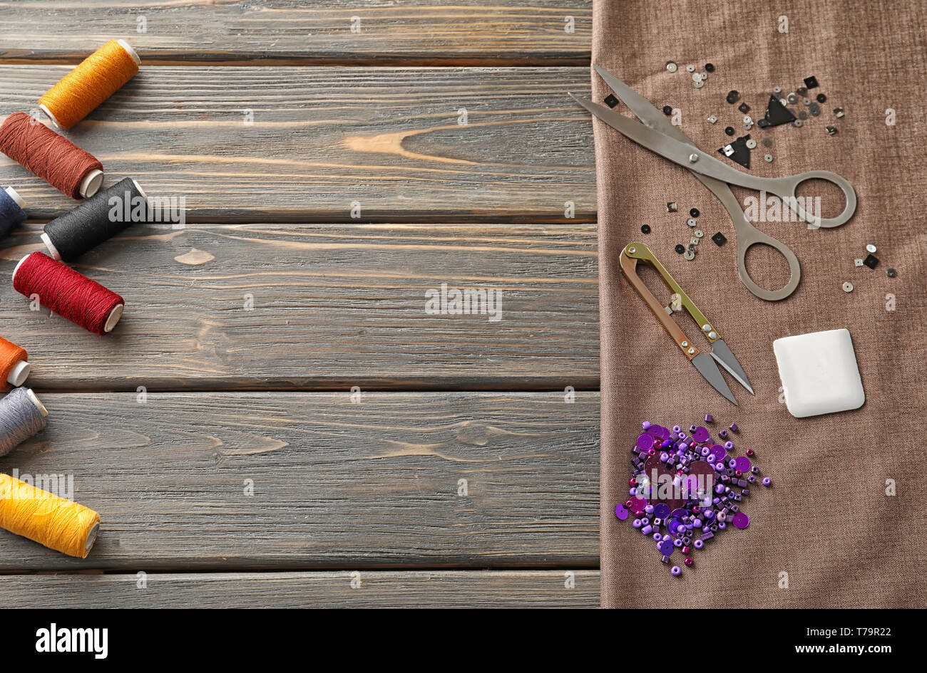 Fabric and sewing accessories on wooden background Stock Photo - Alamy