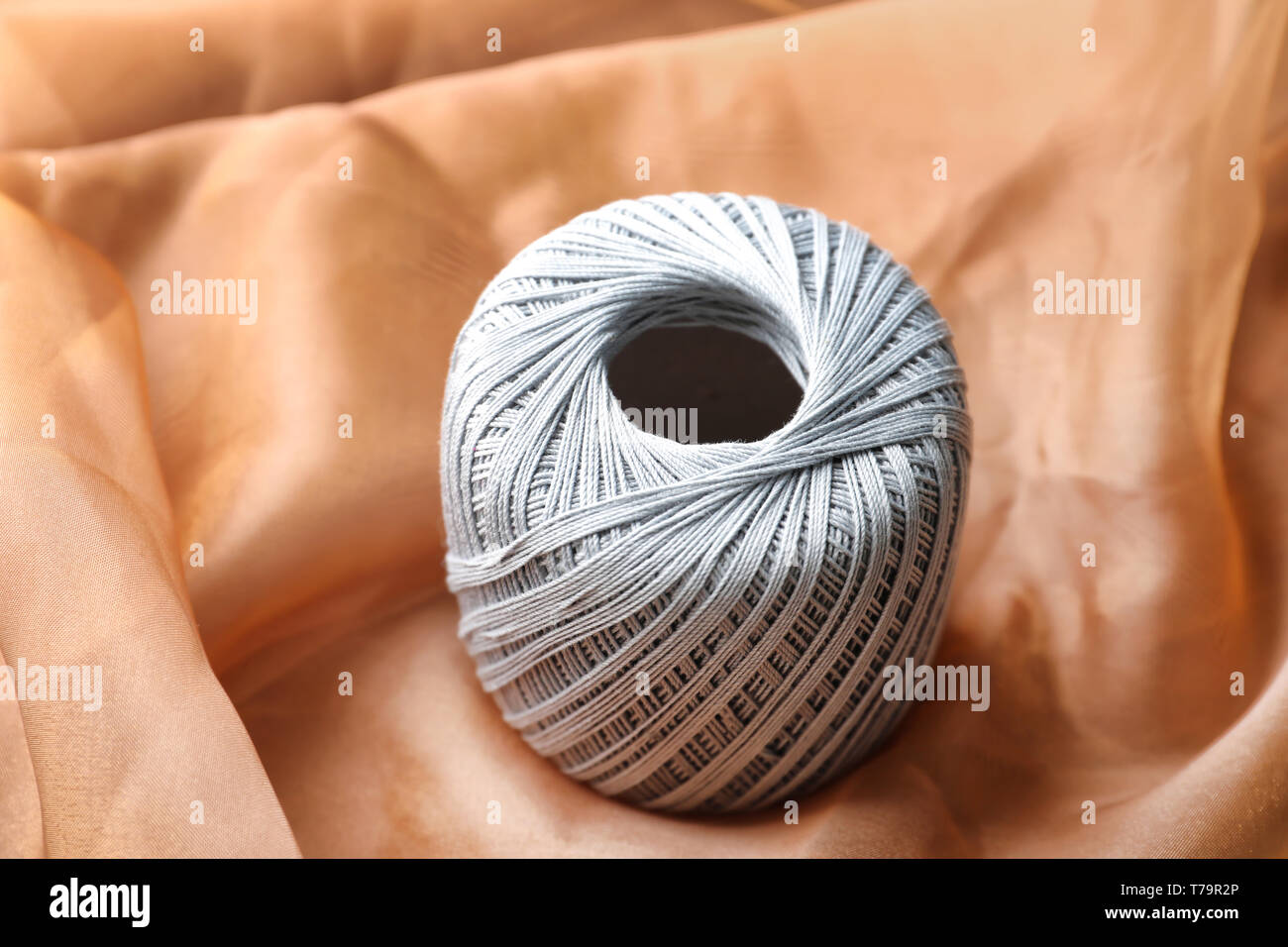 Ball of knitting thread on fabric Stock Photo - Alamy
