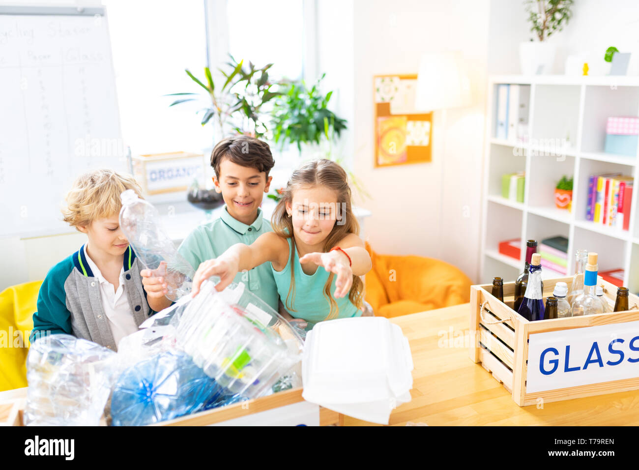 Glass and plastic. Children feeling truly involved in sorting glass and ...