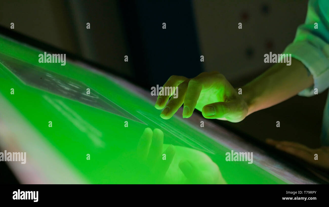 Woman using interactive touchscreen display at modern museum Stock ...