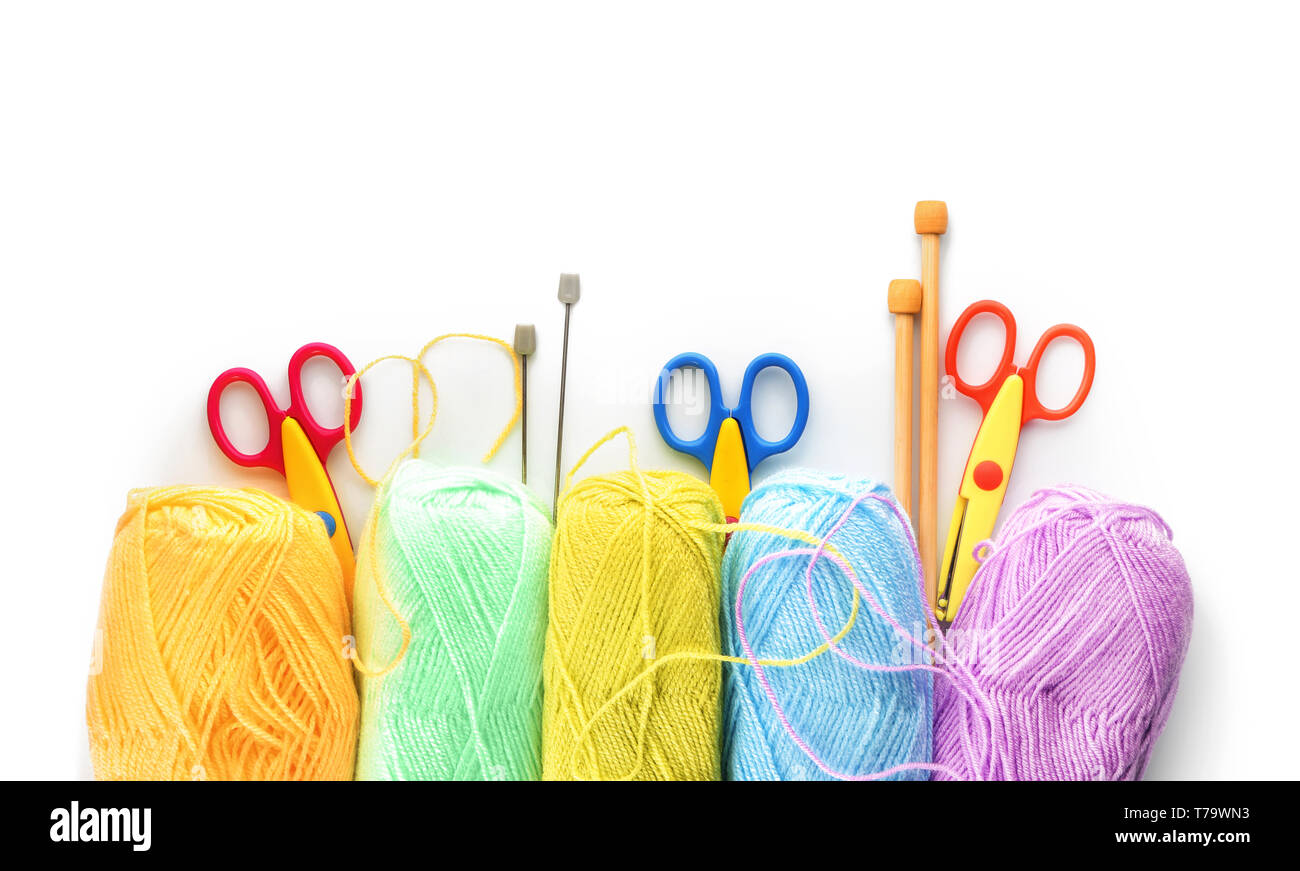 Colorful knitting yarn with needles and scissors on white background ...