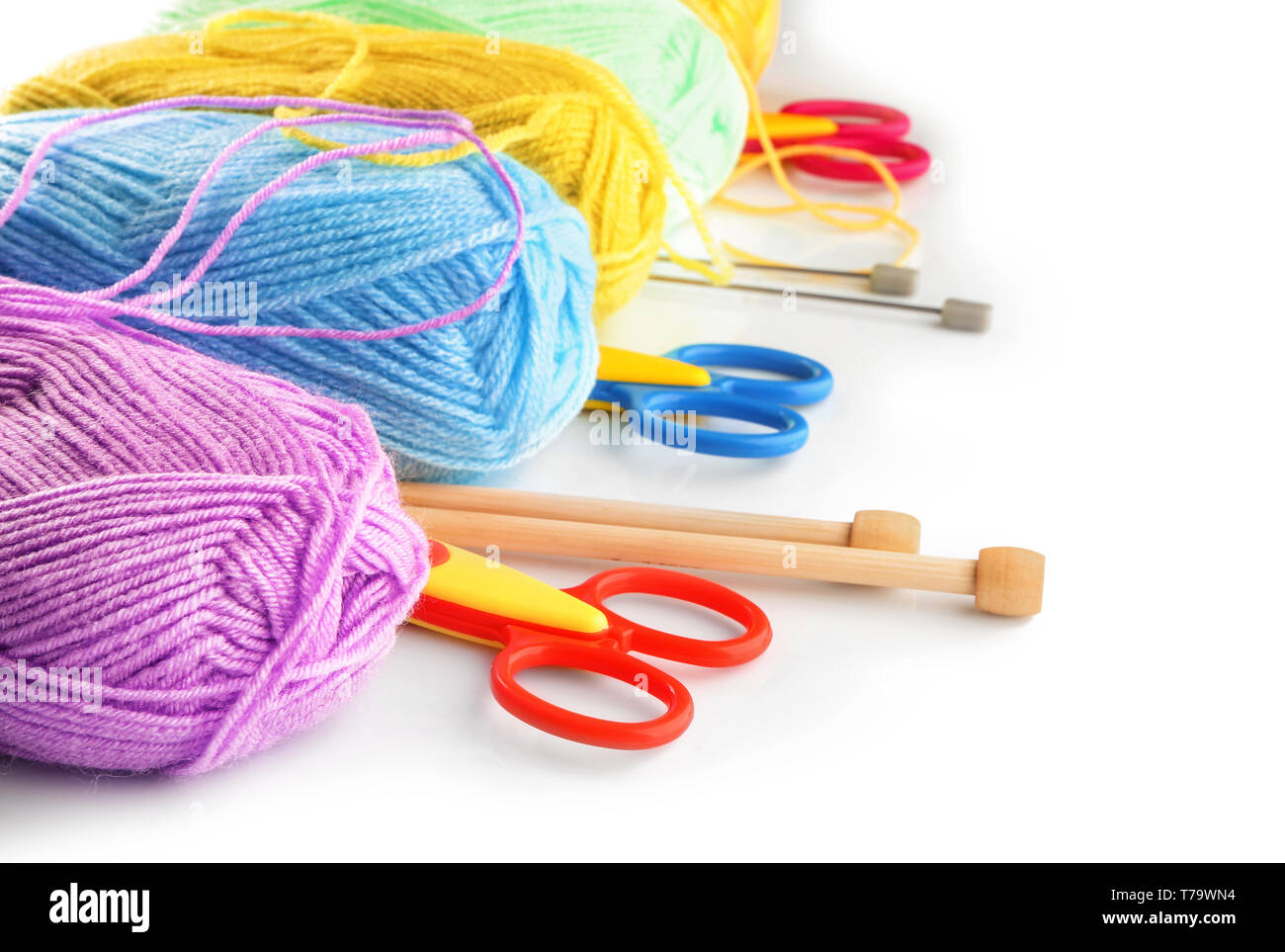 Colorful knitting yarn with needles and scissors on white background ...