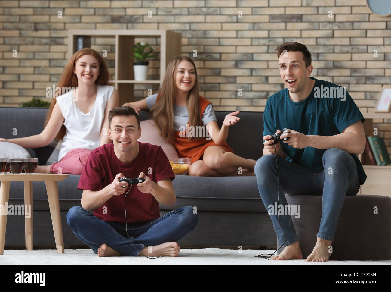 Young people playing video games at home Stock Photo - Alamy
