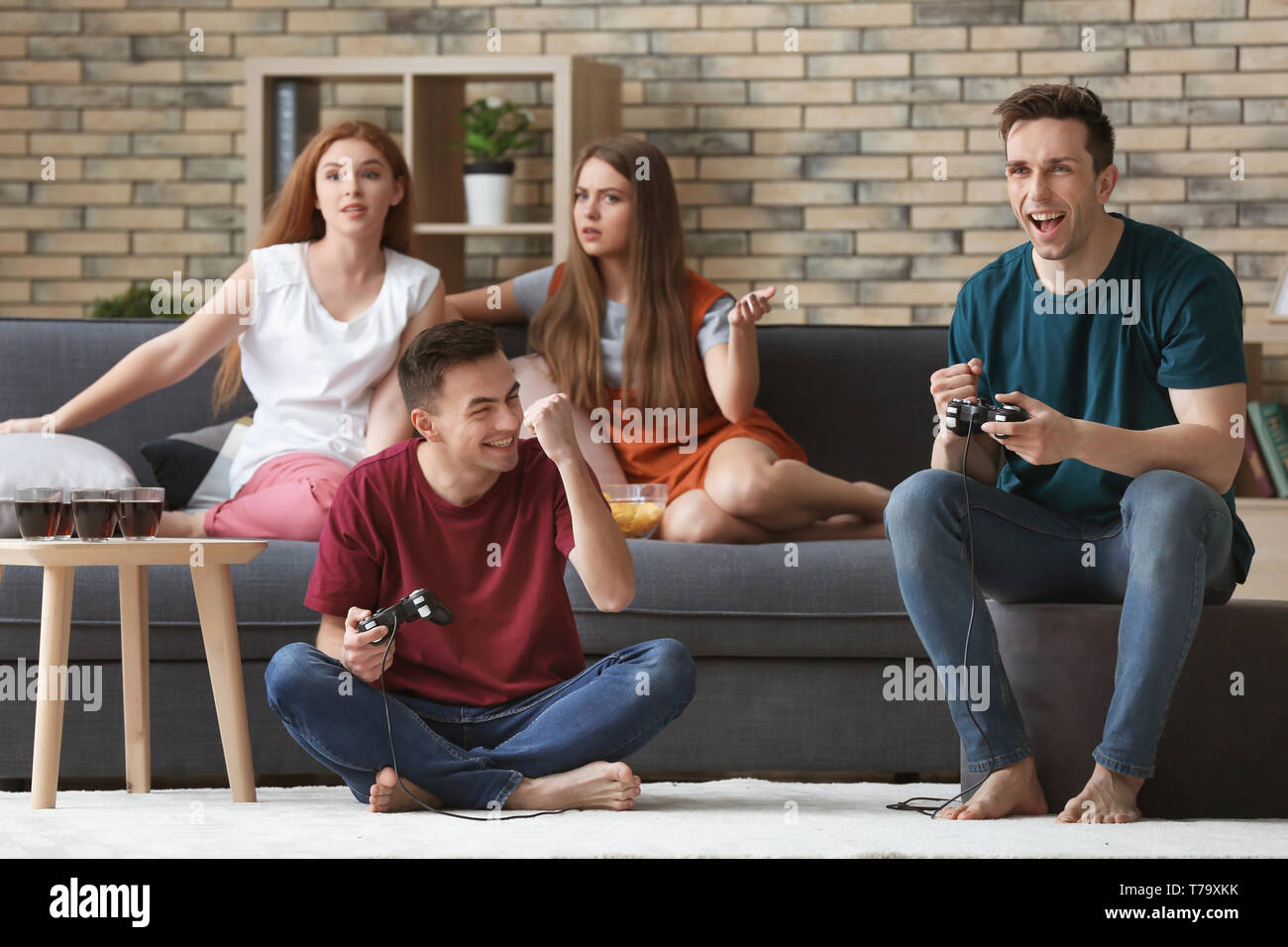Young people playing video games at home Stock Photo - Alamy